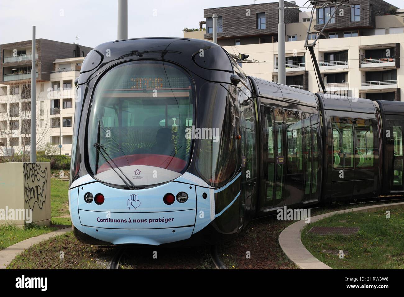 Modern tram in a French city wearing a surgical mask Stock Photo - Alamy