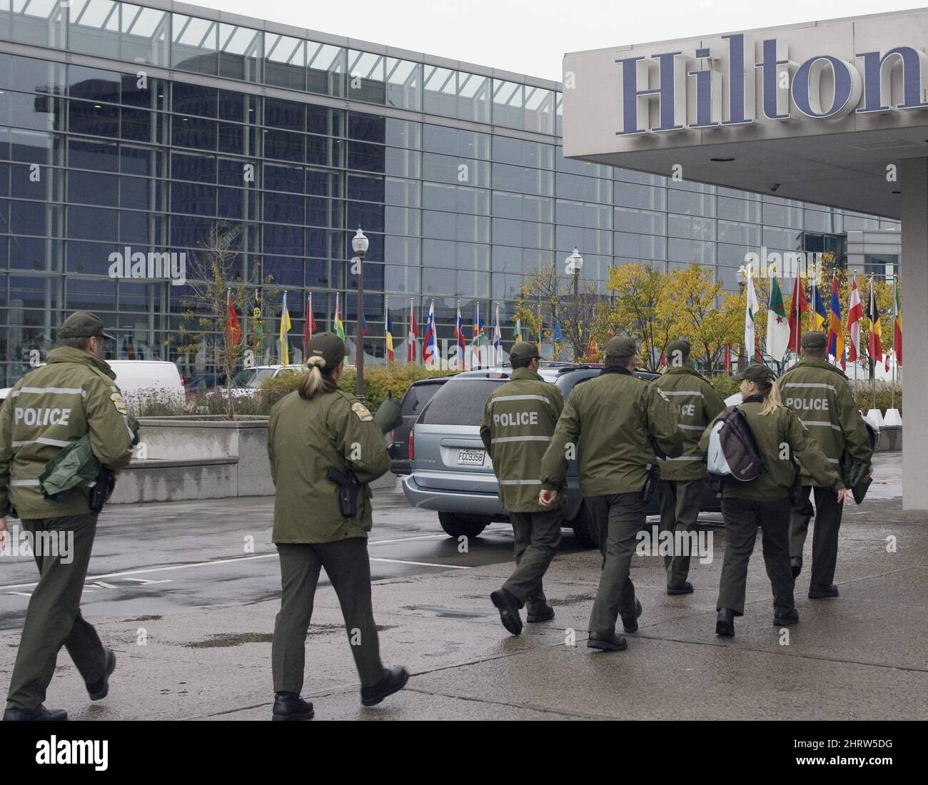 Quebec provincial police officers walk toward the convention centre and ...