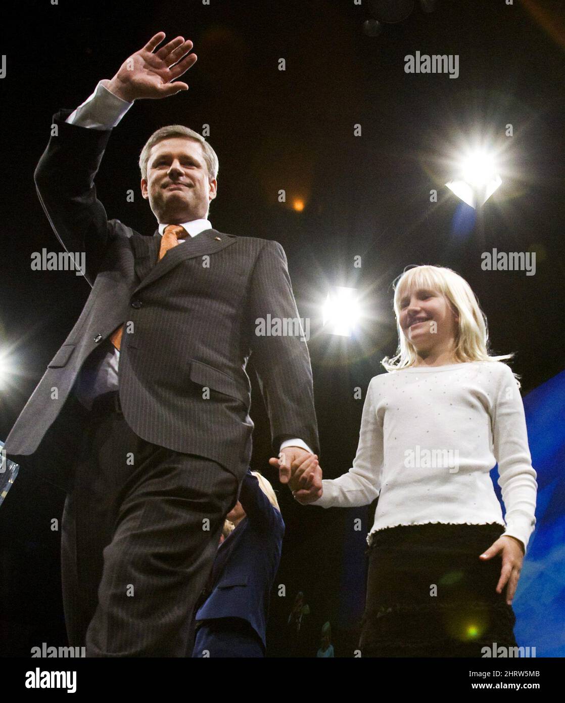 Conservative Leader Stephen Harper waves to the crowd as he and his ...