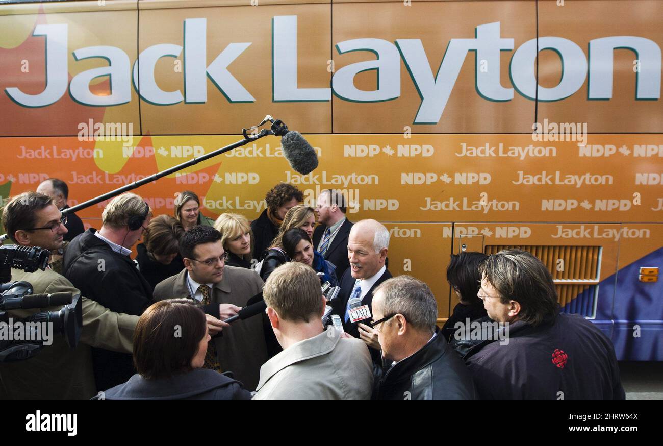 NDP Leader Jack Layton, centre, speaks with reporters during a scrum on ...