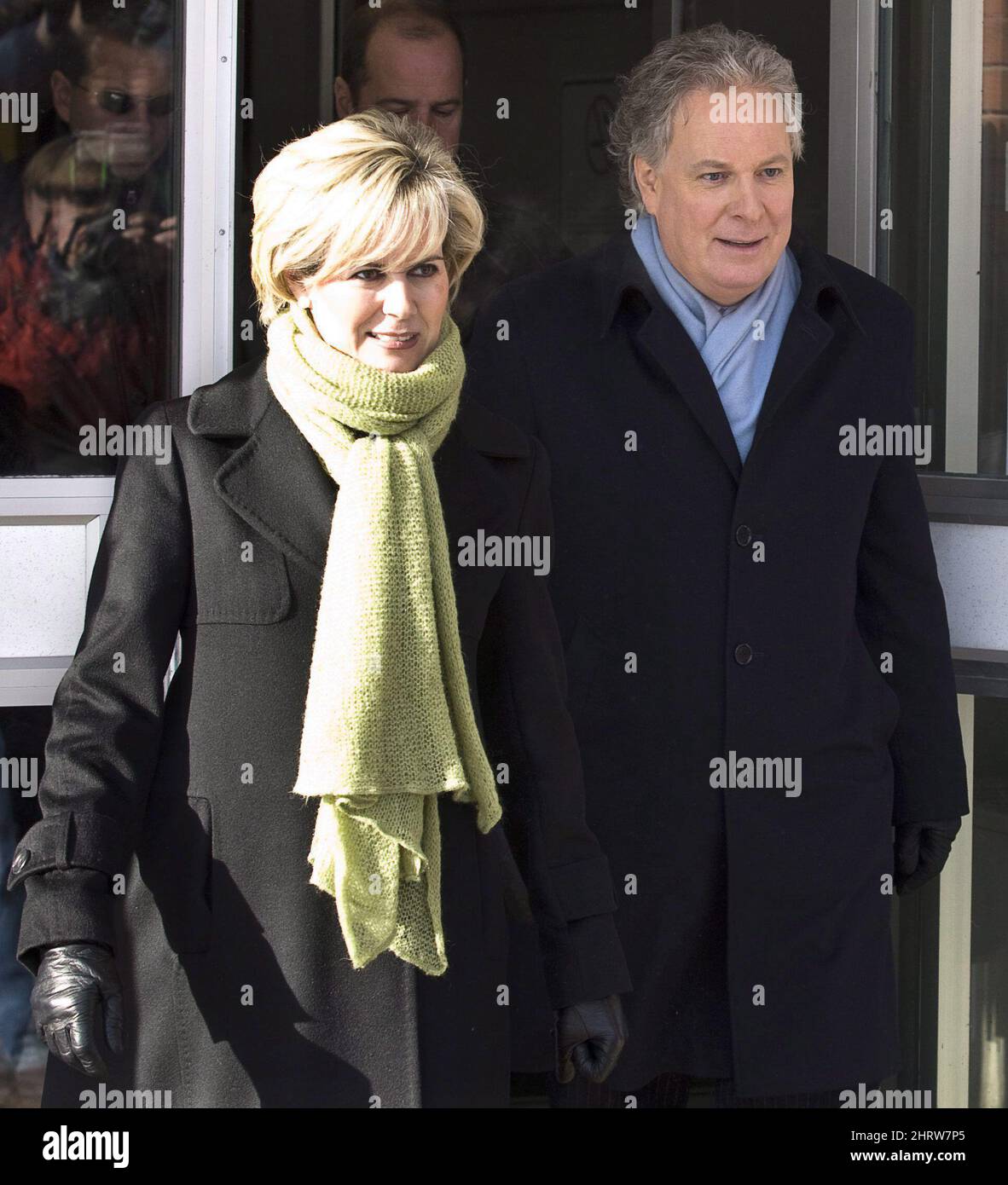 Liberal Leader Jean Charest leaves the polling station accompanied by his wife Michele Dionne ...