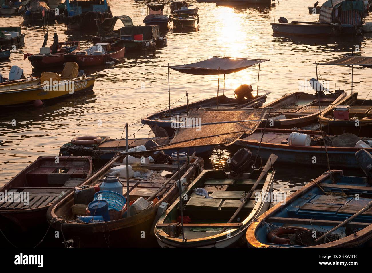 Local fishing boats at sunset at the waterfront of Cheung Chau, an ...