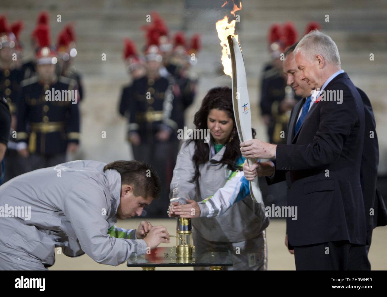 VANOC Chief Executive Officer John Furlong, right, looks on as flame ...
