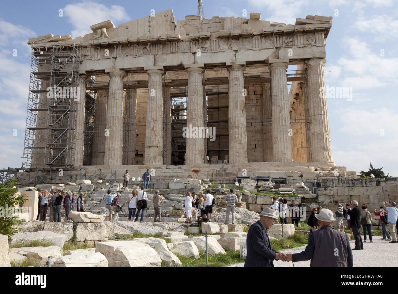The Olympic Flame is dwarfed by the Parthenon as it burns in a cauldron ...