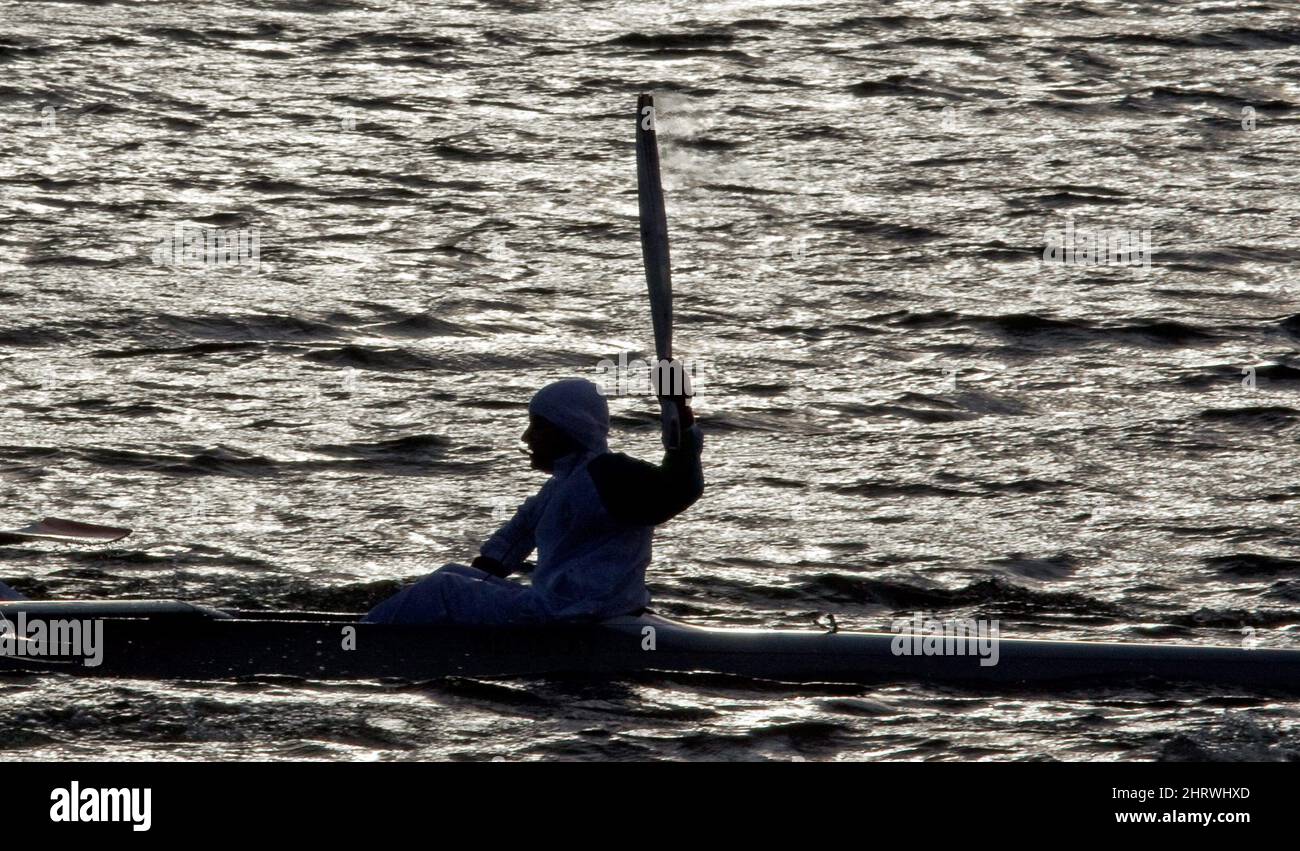 Coxswain Brian Price, of Belleville, Ont., holds the Olympic torch as ...
