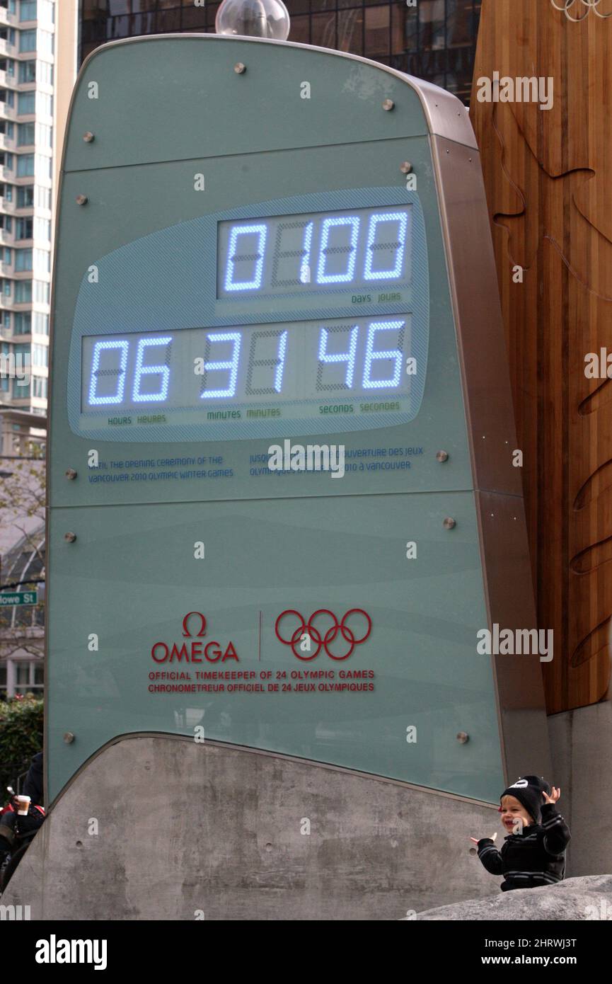 Two-year-old London Paulger cheers as his grandmother takes a photograph of him in front of ...