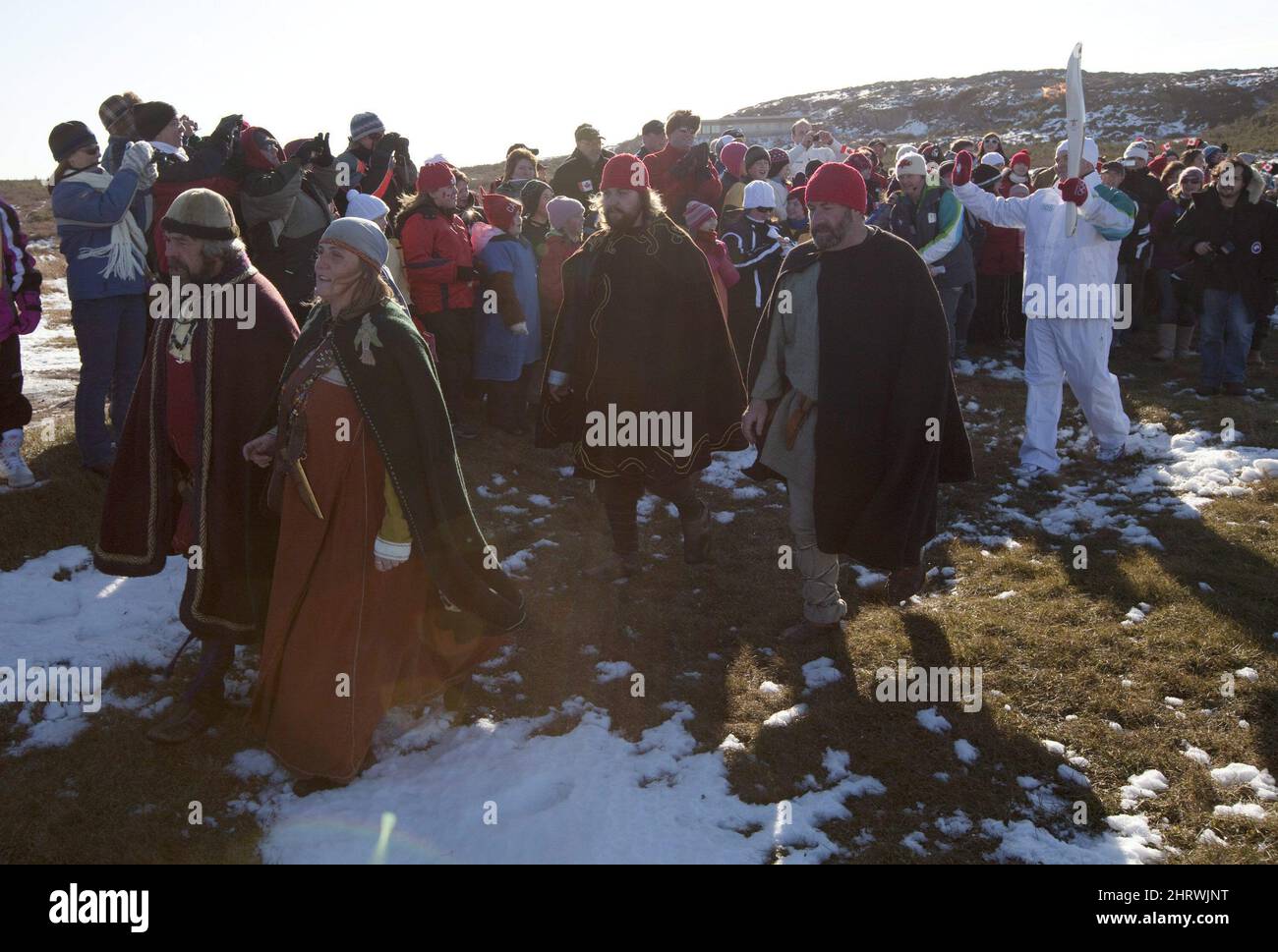 Torchbearer Frank Humber is led by Viking impersonators as carries the ...