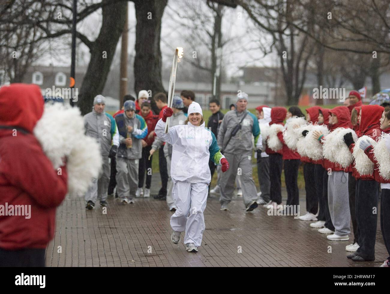 Odette Tremblay of Quebec City is greeted by young cheerleaders as she ...