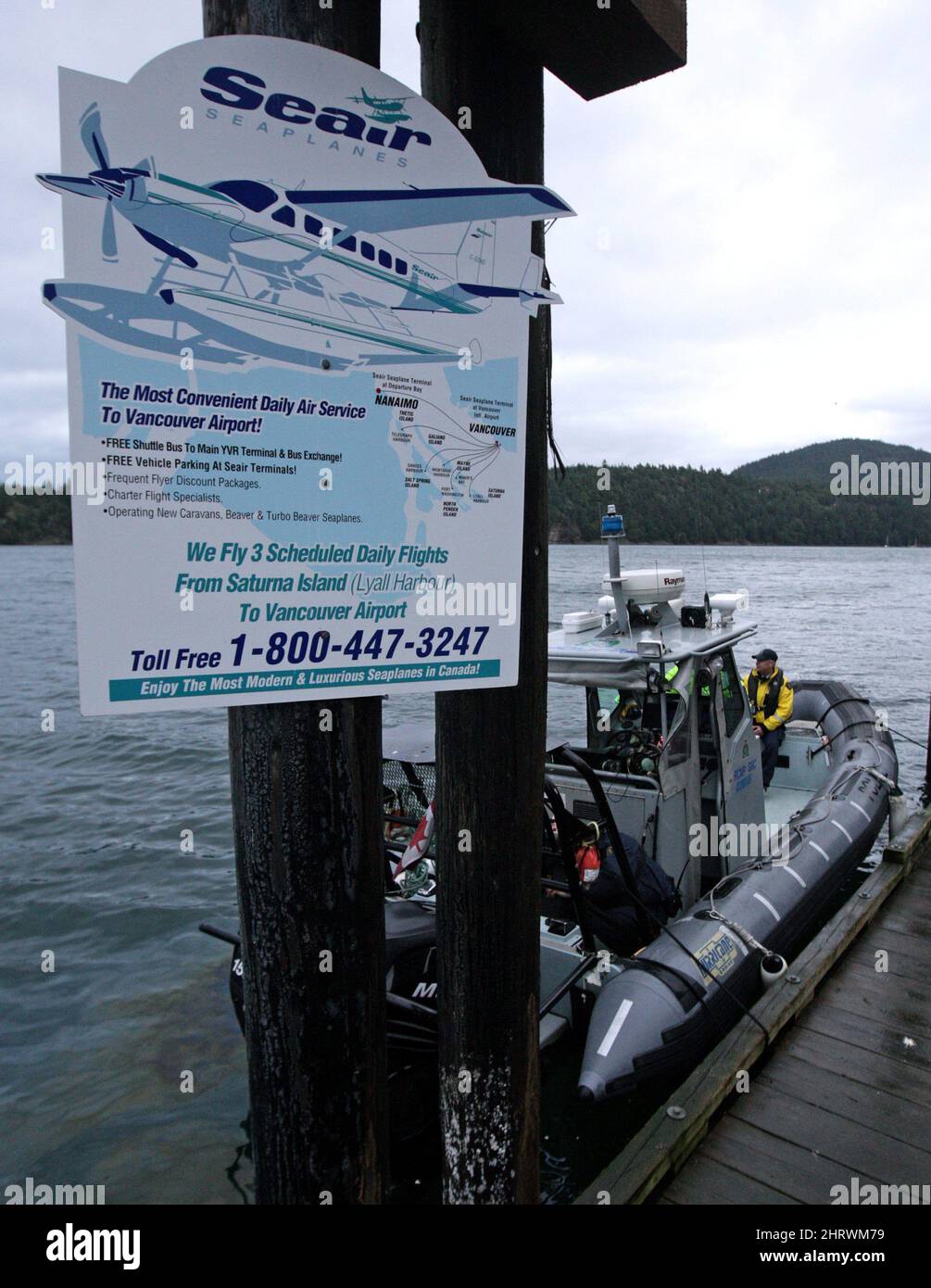 RCMP officers sit on a boat at a boat and float plane dock on Lyall ...
