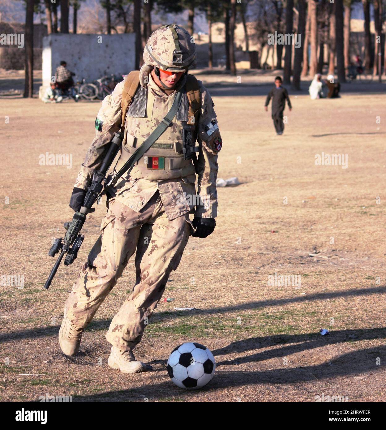 Canadian Cpl. Justin Artibise kicks a soccer ball at an Afghan army ...