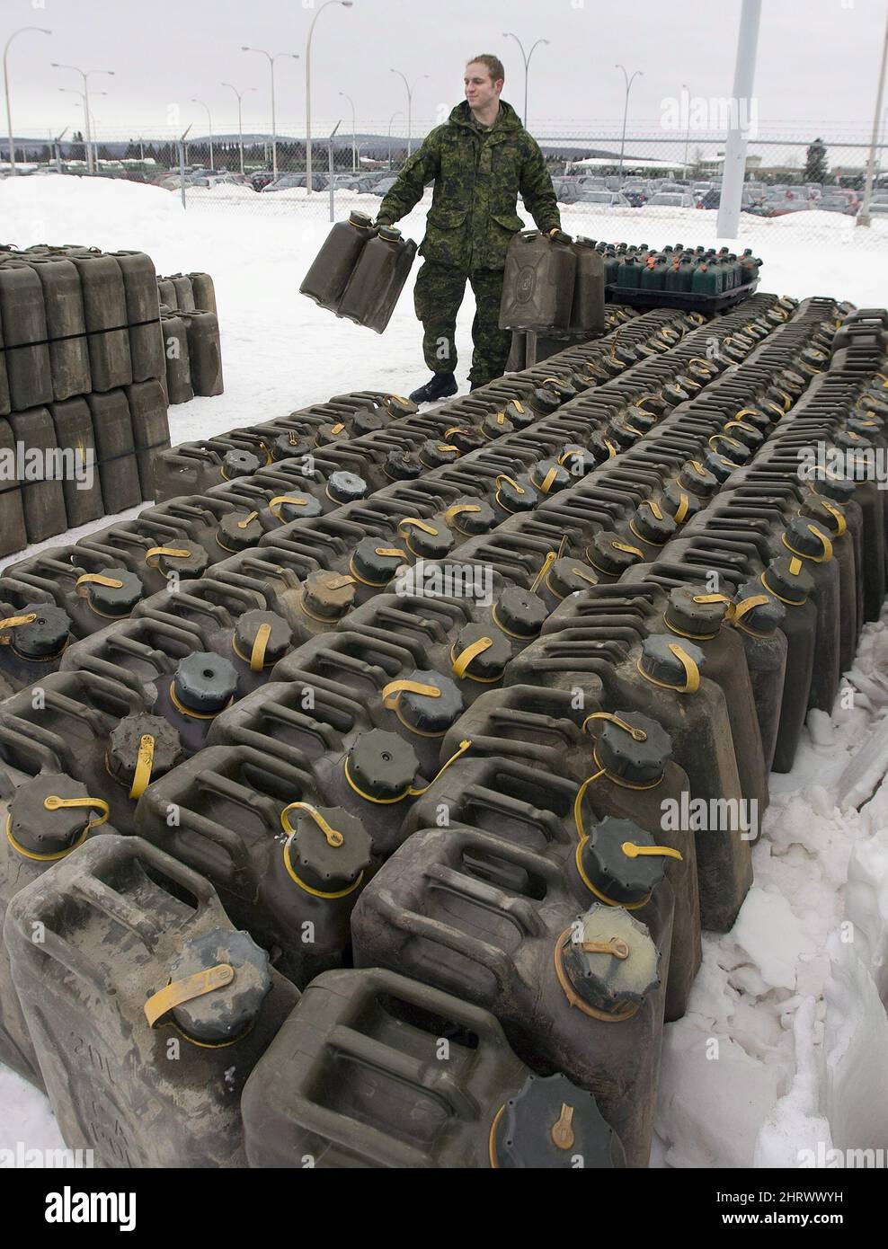 Canadian Forces Cpl. Dave Massicotte stacks jerrycans in preparation ...