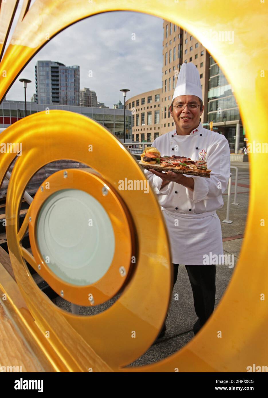 Chef Andrew George Jr. is framed by First Nations artwork as he ...