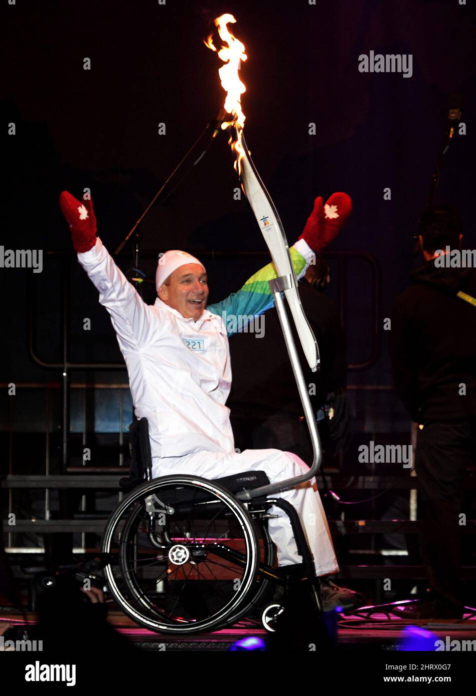 Six time Parlaympic medalist Rick Hansen, of Richmond, B.C., carries ...
