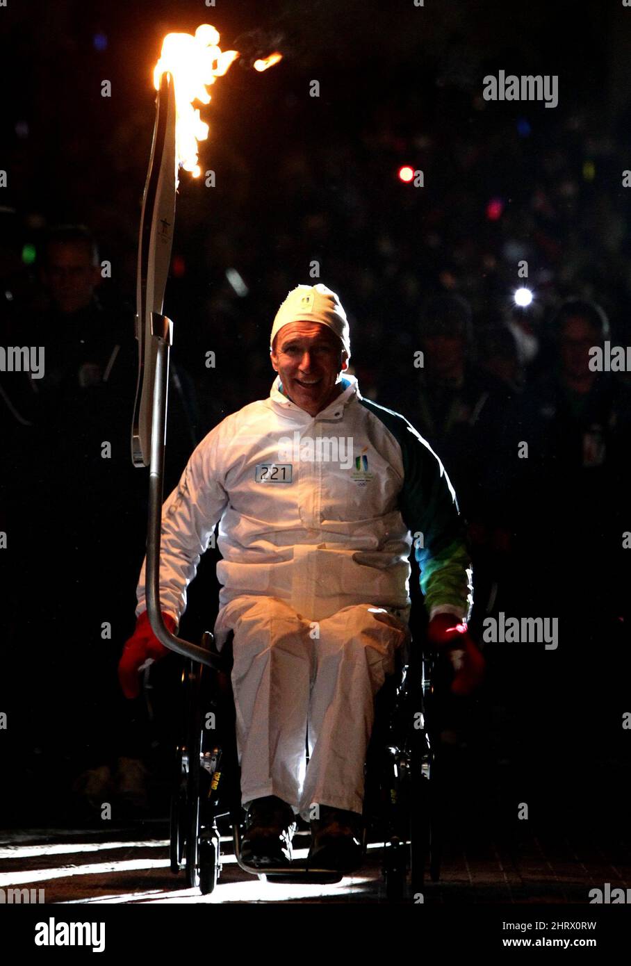 Six time Parlaympic medalist Rick Hansen, of Richmond, B.C., carries ...