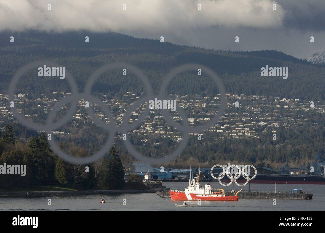 A set of Olympic Rings frame a Canadian Coast Guard ship as it sails in ...
