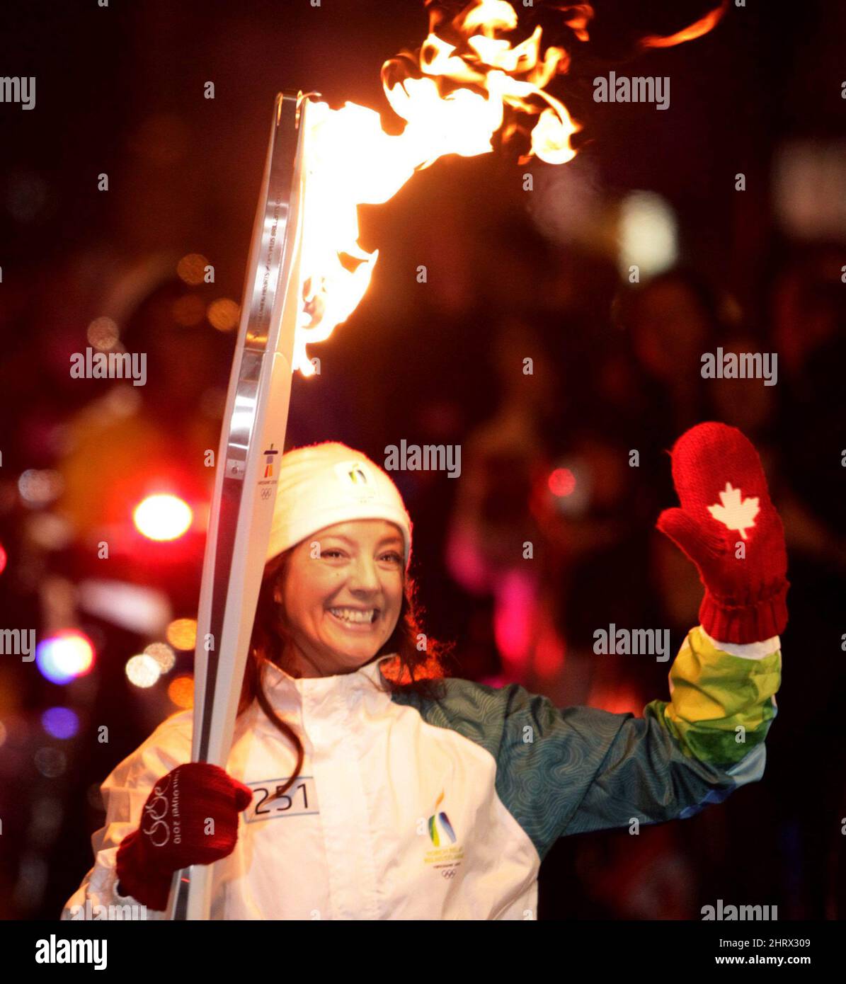 Canadian singer Sarah McLachlan carries the Olympic flame during the ...