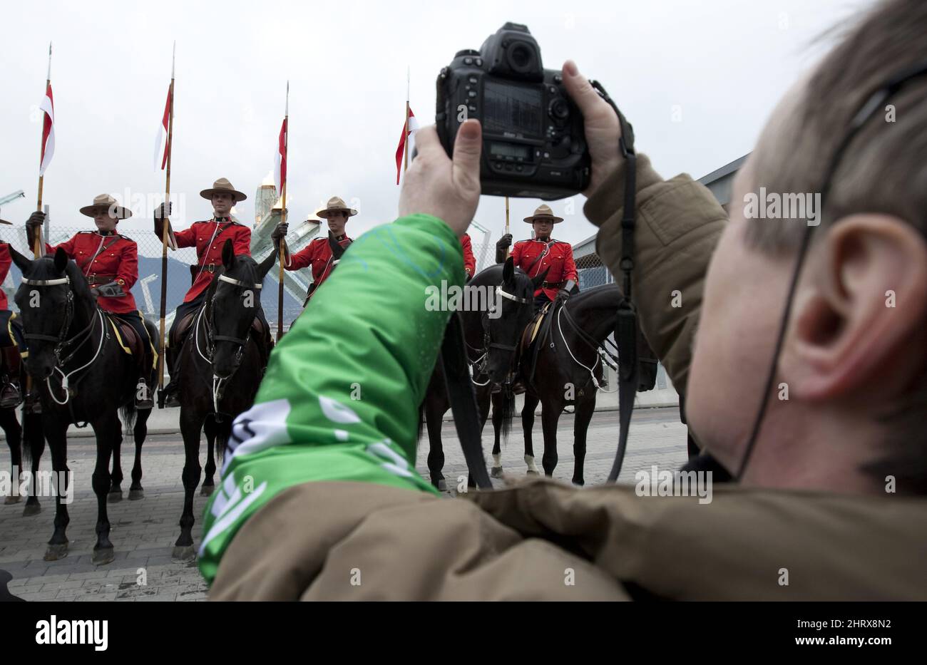 A photographer takes pictures of members of the RCMP Musical Ride pose ...