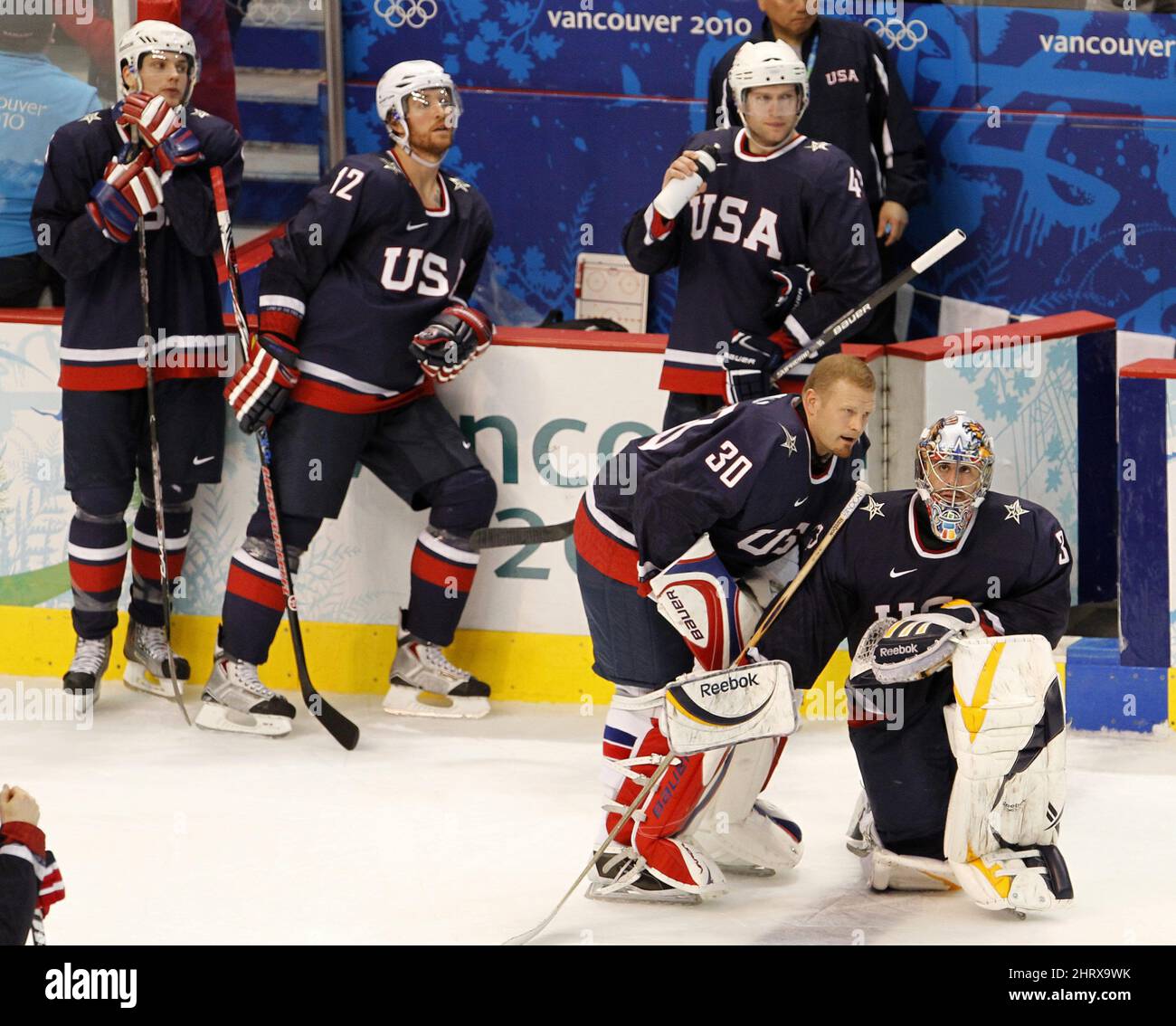 USA goalie Tim Thomas consoles teammate Ryan Miller, right, during ...
