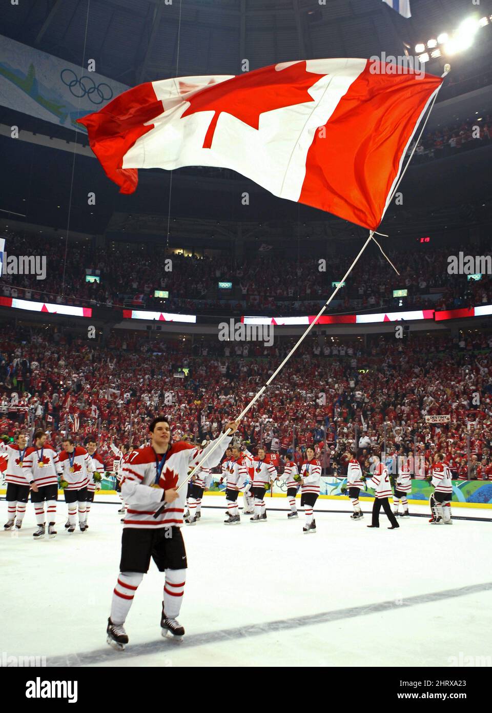 Canada's Sidney Crosby skates with tha flag after scoring the overtime ...