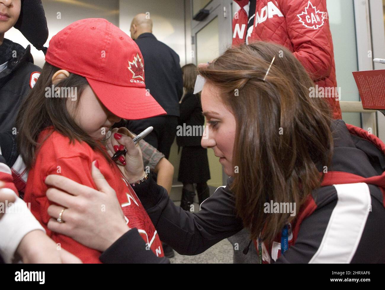 Figure skater Vanessa Crone (right) signs an autograph for four-year ...