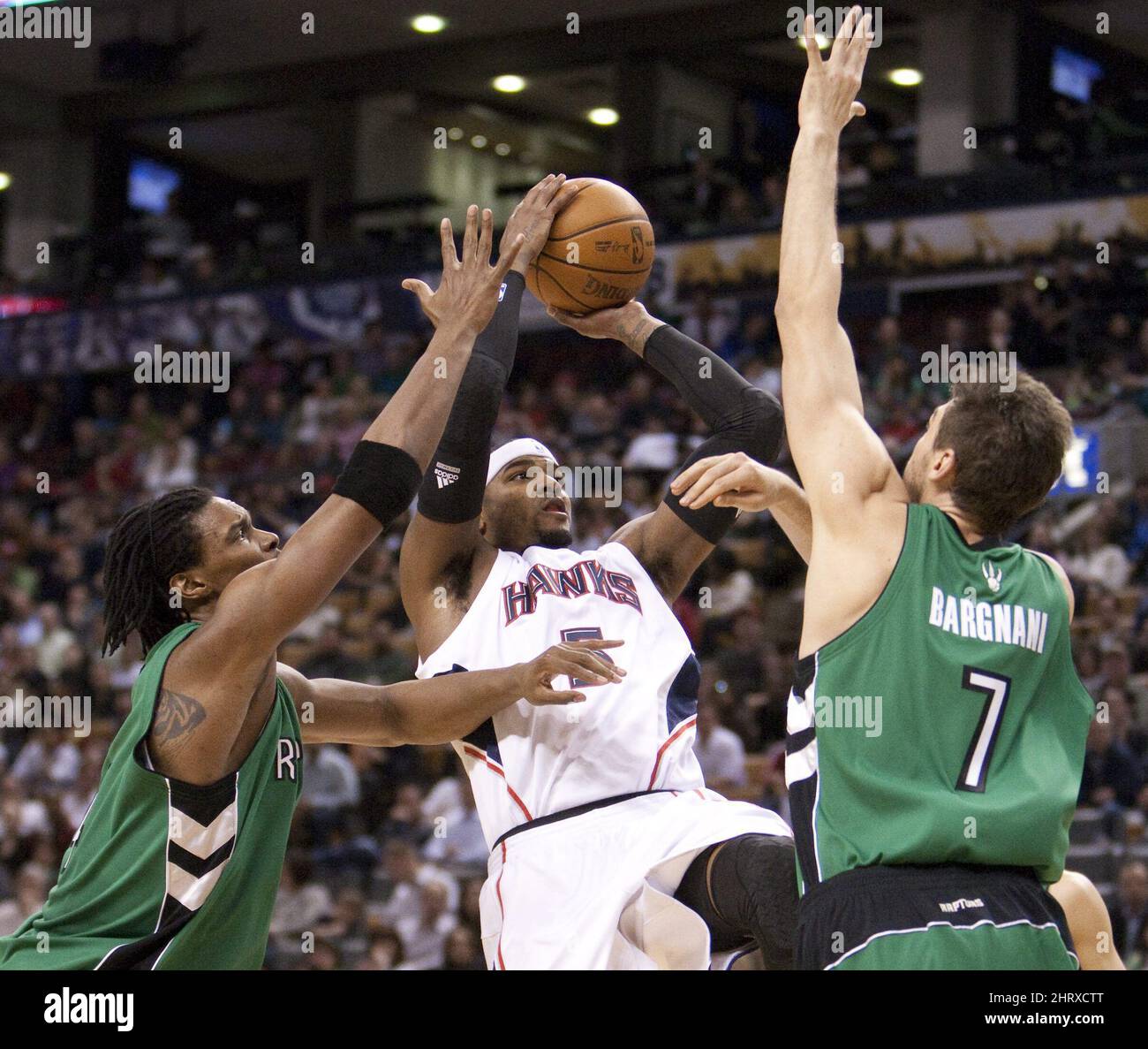 Toronto Raptors forwards Chris Bosh (4) and Andrea Bargnani (7) try to ...