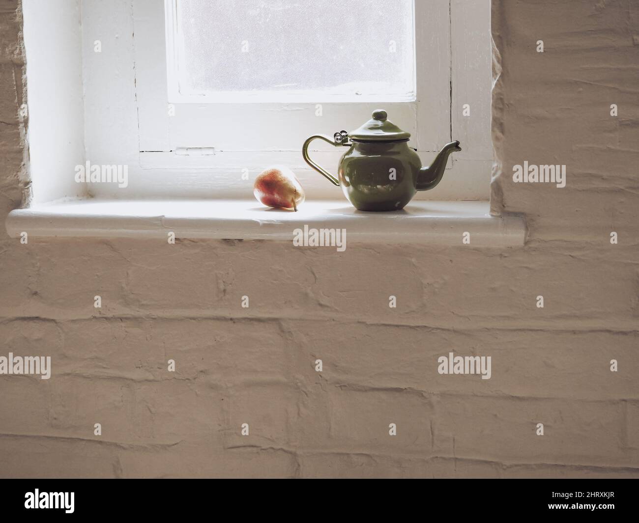 Closeup shot of an old kettle and a pear on a windowsill Stock Photo ...