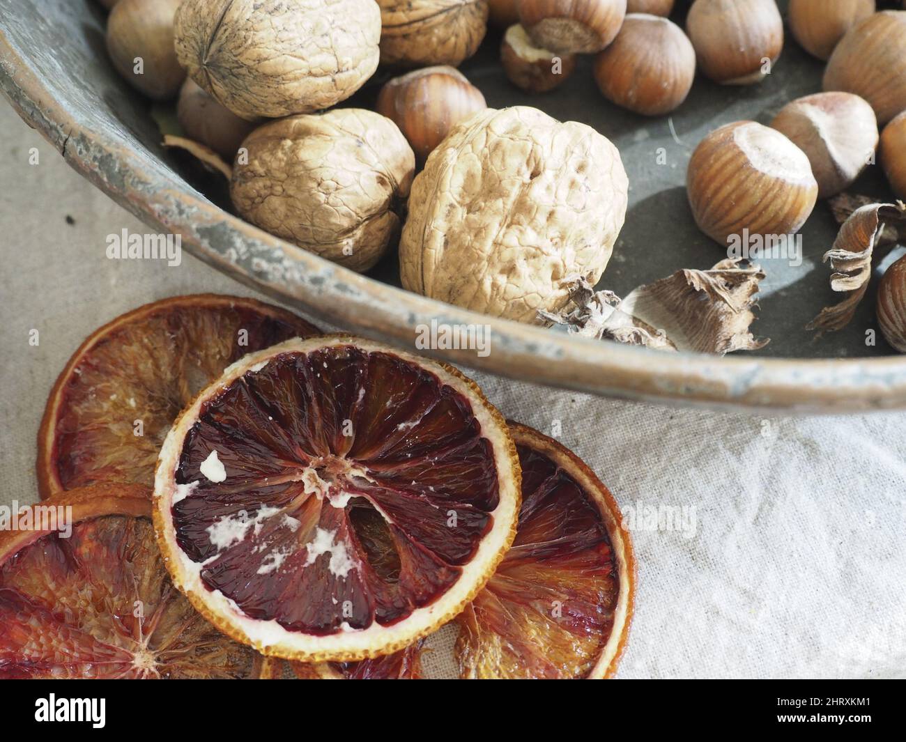 Closeup aesthetic shot of different nuts in a bowl and dried red-orange ...