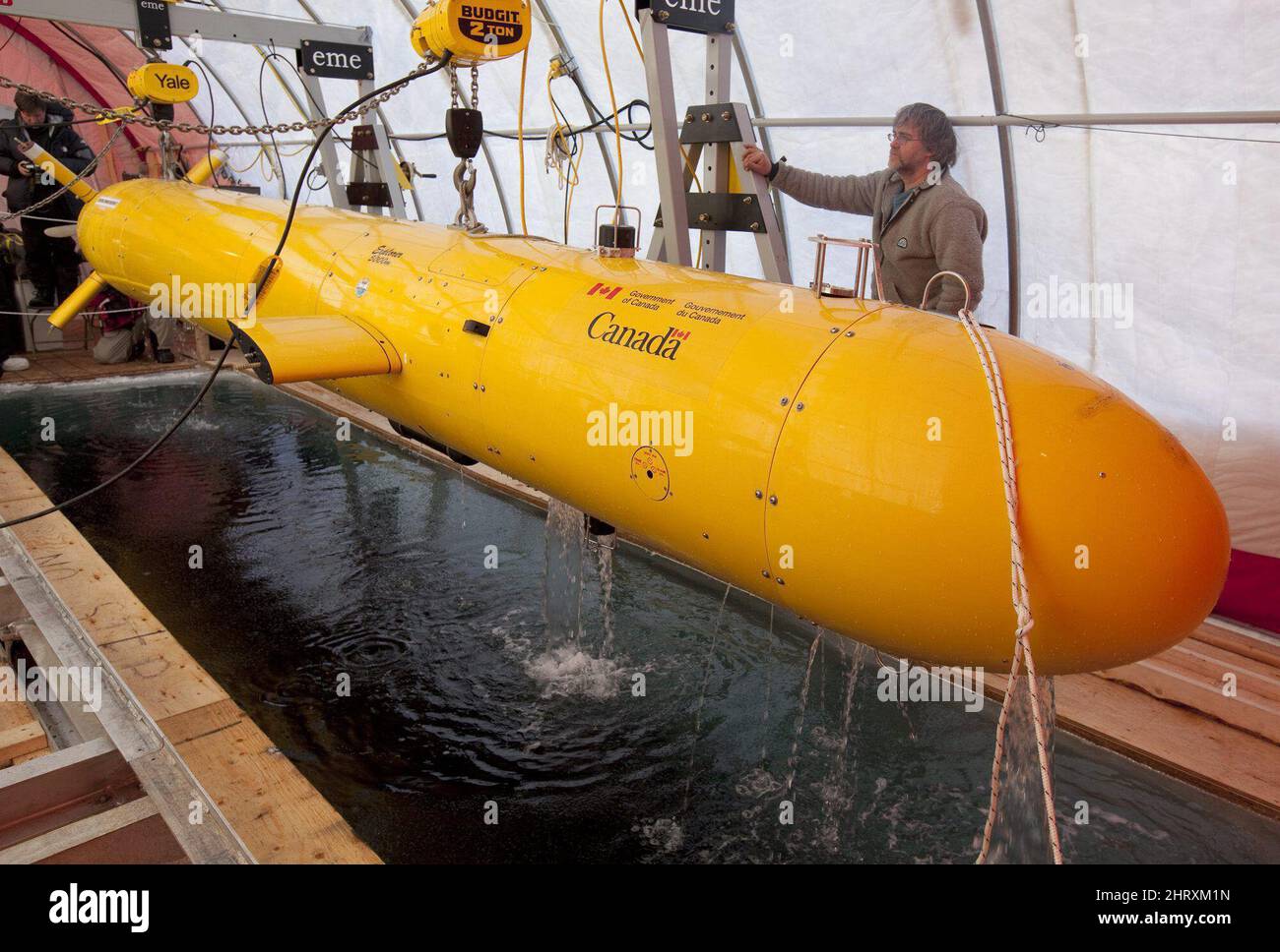 The automated unmanned submersible vehicle is lifted out of the water ...