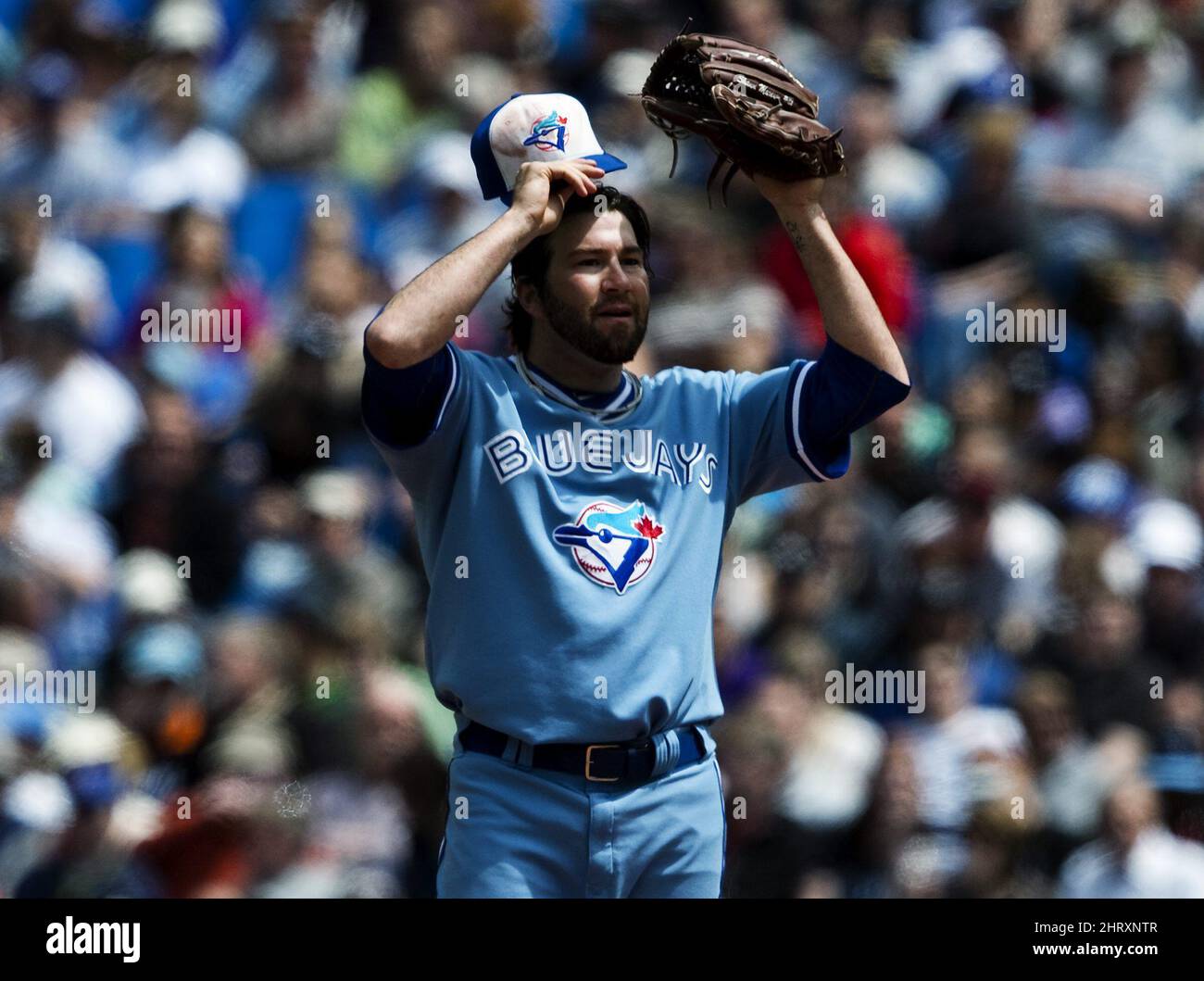 Toronto Blue Jays starting pitcher Shaun Marcum lifts his cap while ...