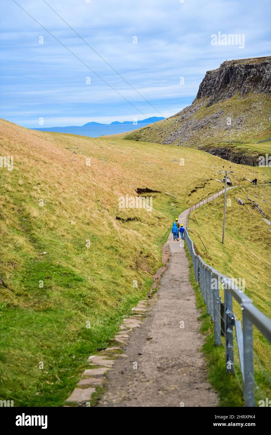 A green Mountain Path with beautiful blue sky in isle of Skye Scotland ...