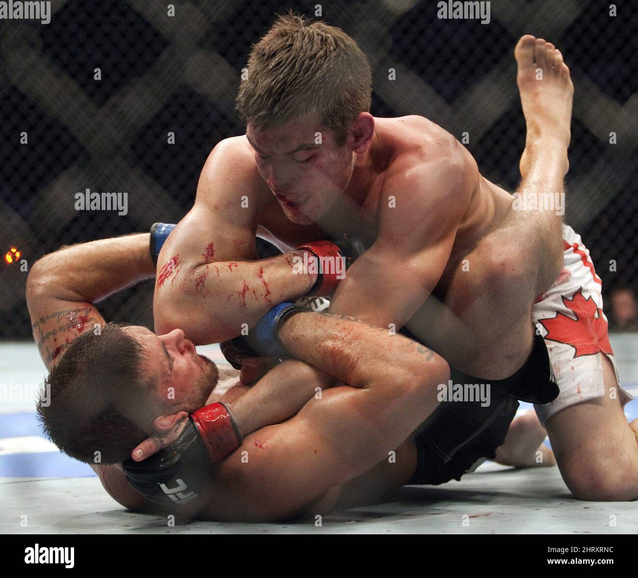 Sam Stout, top, from London, Ont., lands an elbow to the head of Jeremy ...