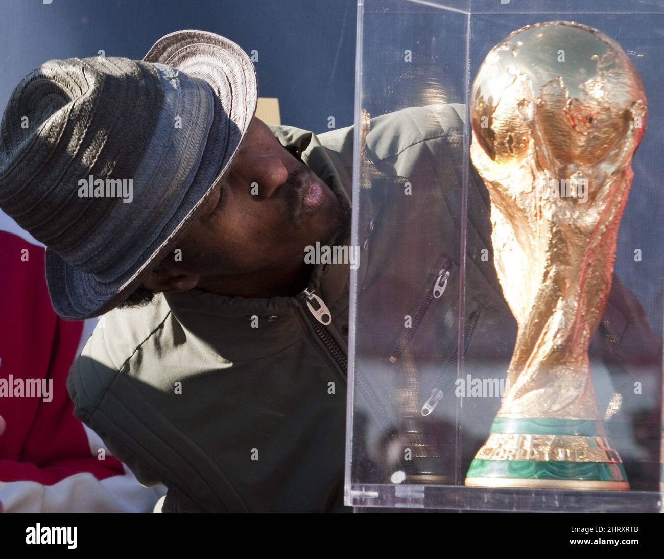 Singer K'NAAN smiles as he stands behind the FIFA World Cup trophy ...