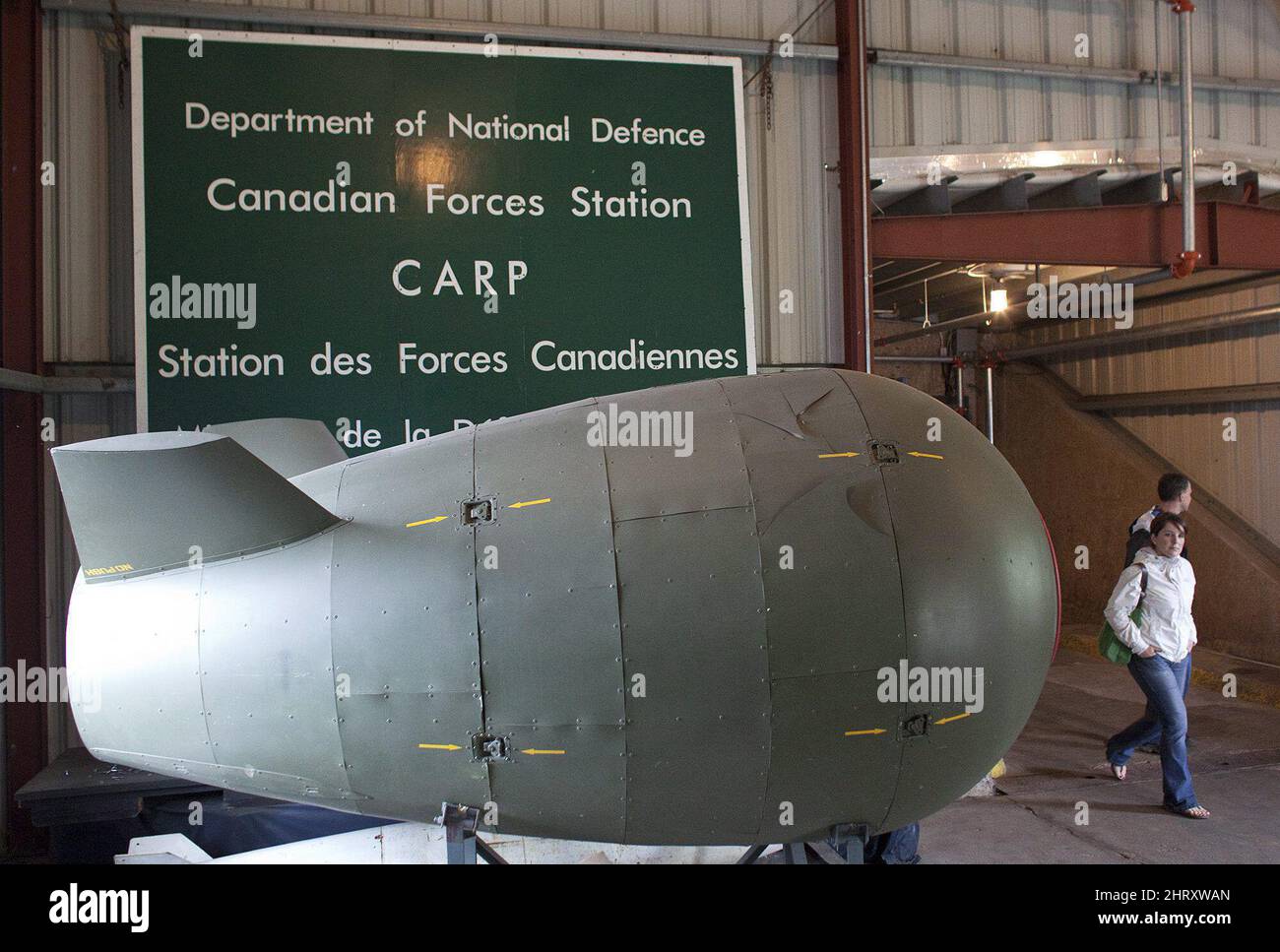 People walk past an MK-4 Atomic Bomb replica while exiting the ...