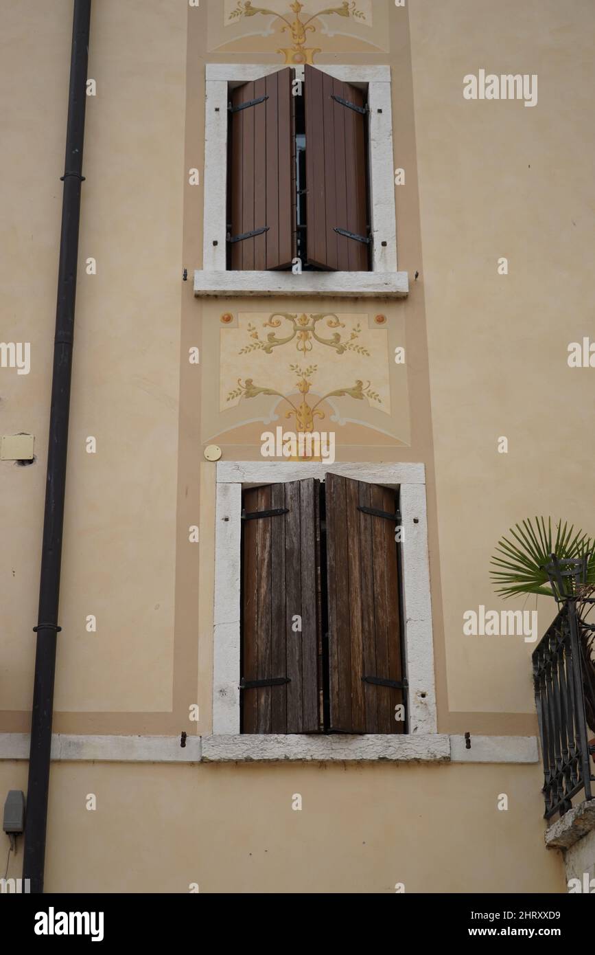 Facade of a building and windows with wooden shutters Stock Photo - Alamy