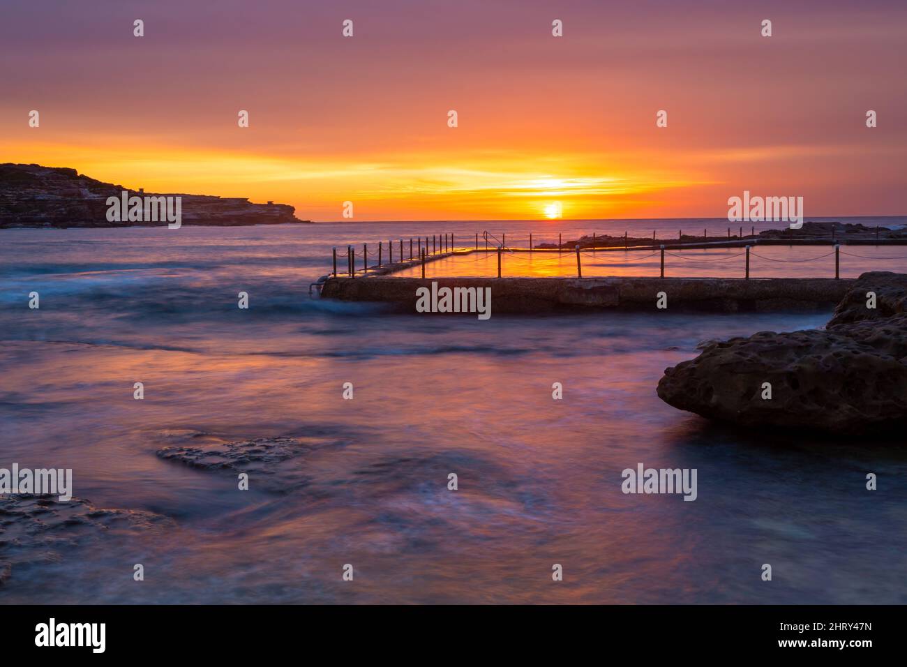 Stunning sunrise at Malabar ocean rock pool Stock Photo - Alamy