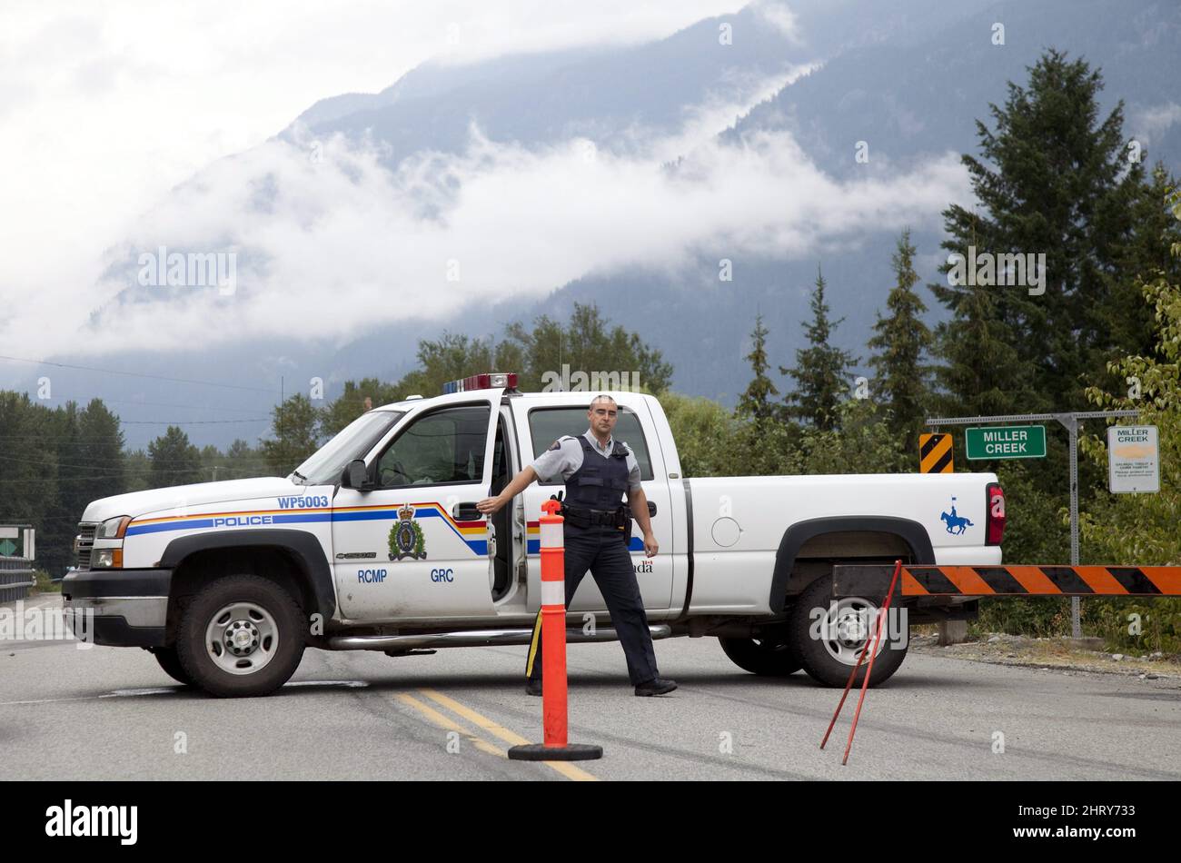 A member of the RCMP prepares to remove a barricade from a road just ...