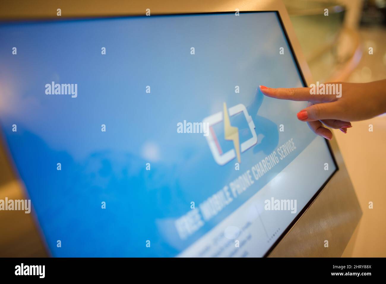 Close-up of female hand on touch screen information counter in shopping ...
