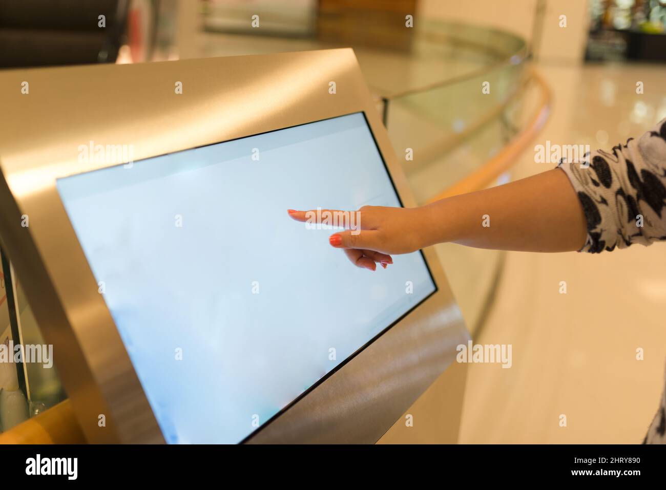 Woman using interactive touchscreen display at urban exhibition ...