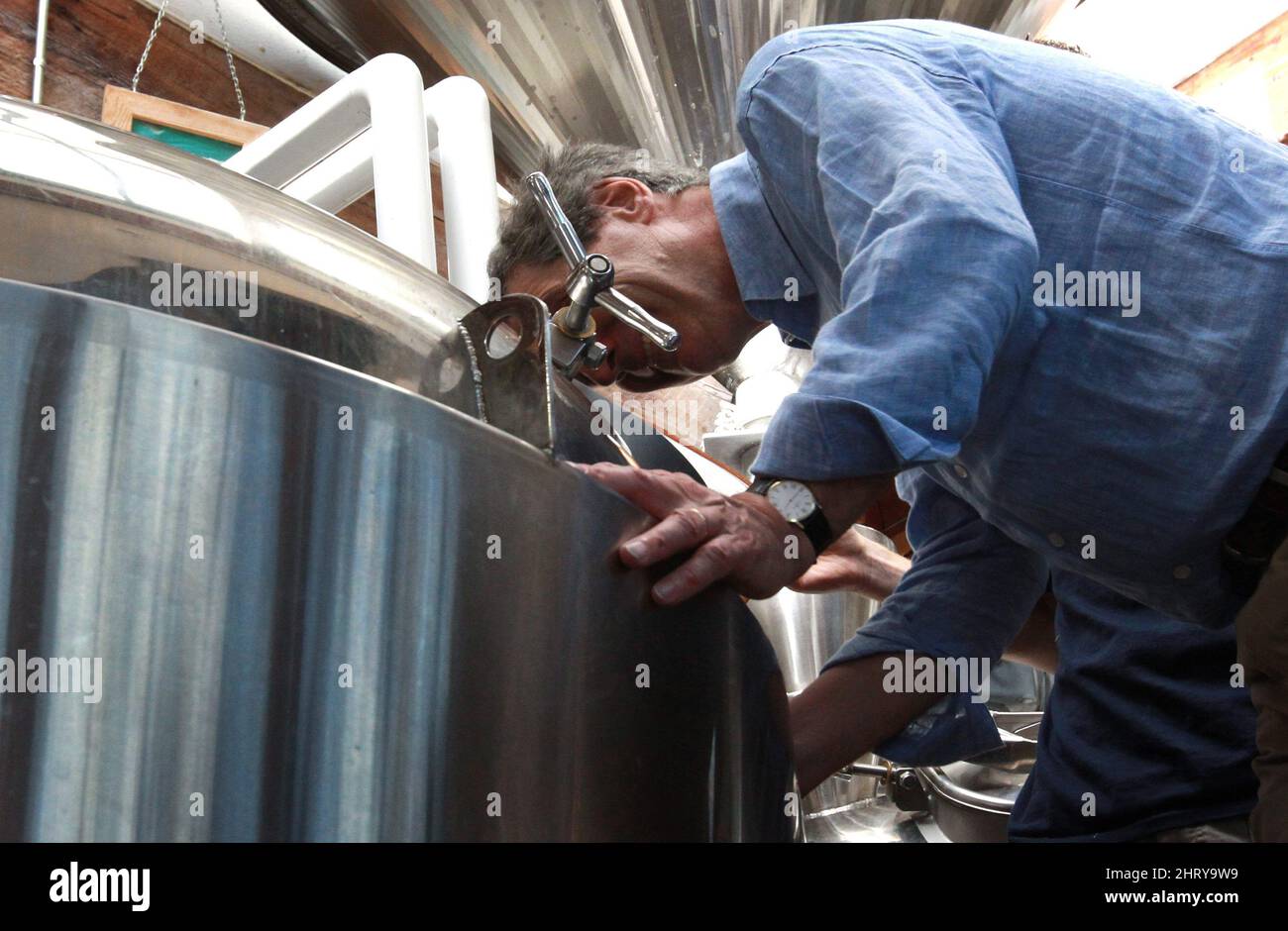 Liberal leader Michael Ignatieff looks into a mash mixer during a tour ...