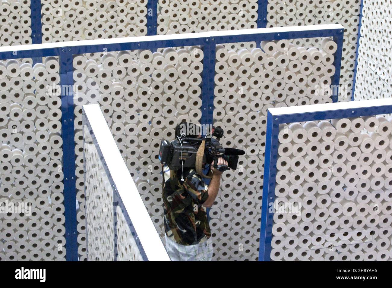 A television camera man tours a toilet paper maze built to illustrate ...