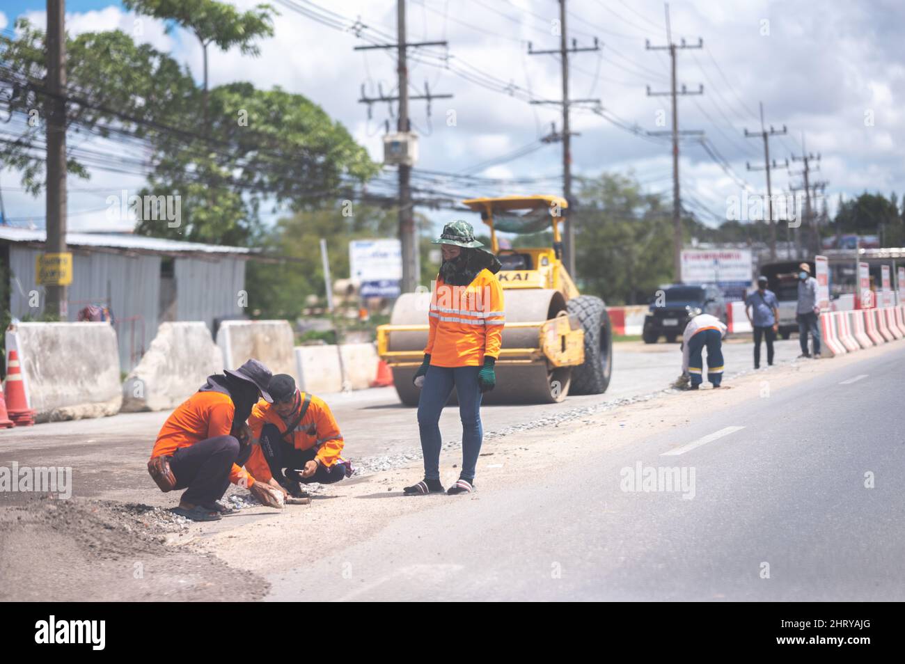 Workmen on the main road in Thailand working during hot weather Stock ...