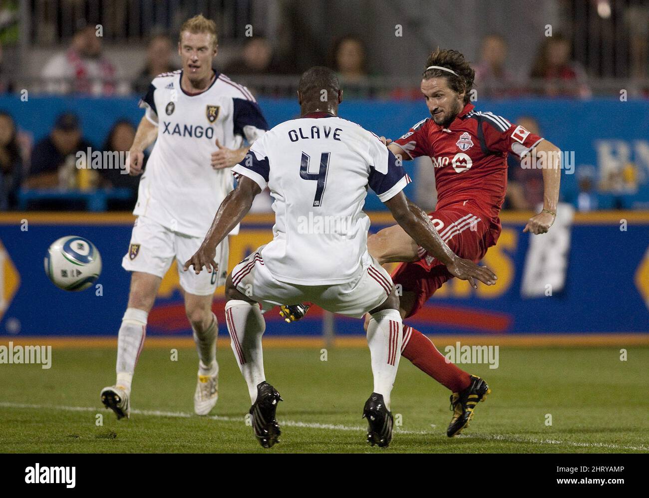 Toronto FC's Mista (right) takes a shot at goal despite pressure from ...
