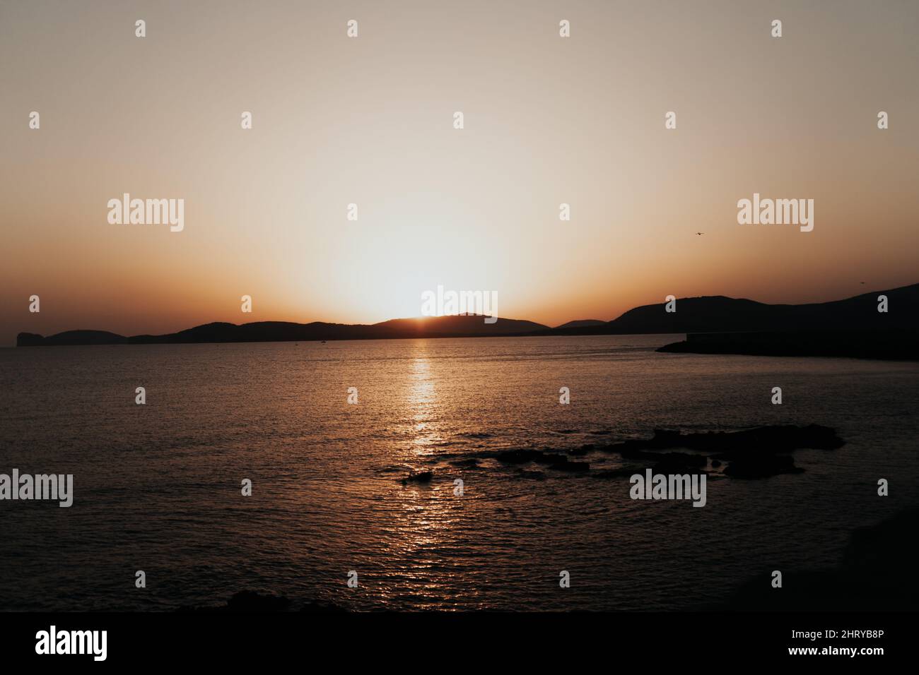 Beautiful golden sunset shining over the sea with a clear cloudless sky ...