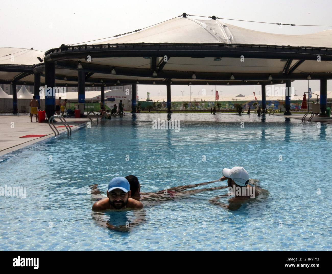 Memebers of India's field hockey team cool off in the pool at the ...