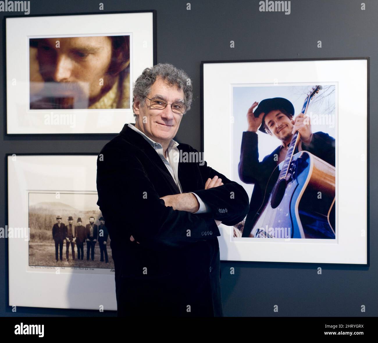 Elliott Landy poses next to photographs at his exhibition 'Elliott ...