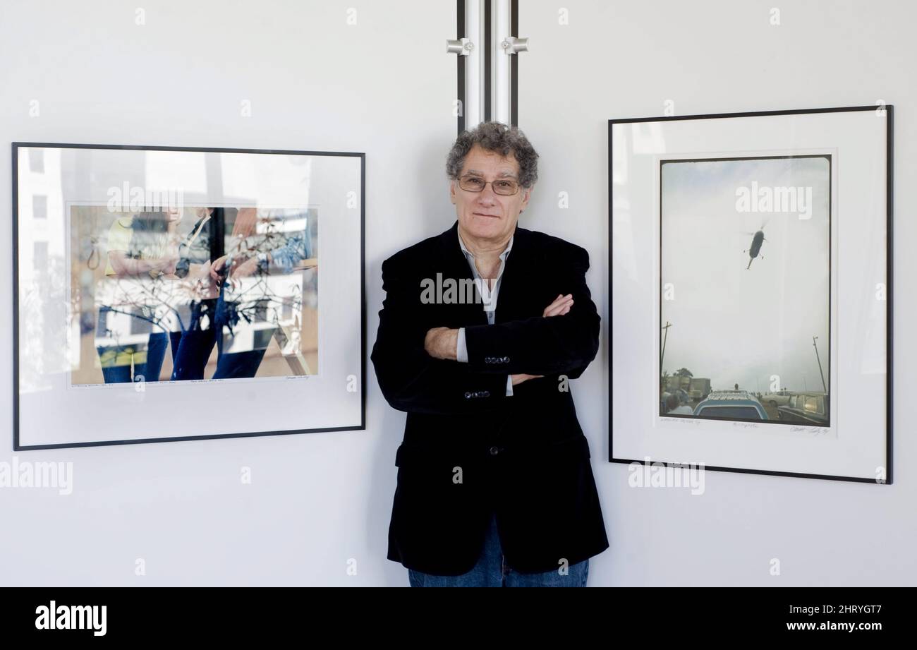 Elliott Landy poses next to photographs at his exhibition 'Elliott ...