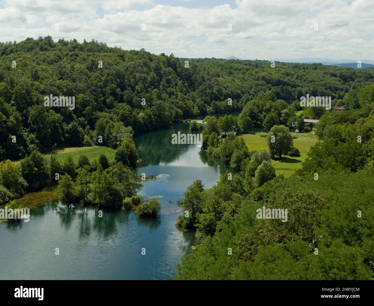 Landscape of The Mreznica surrounded by greenery on a sunny day in ...