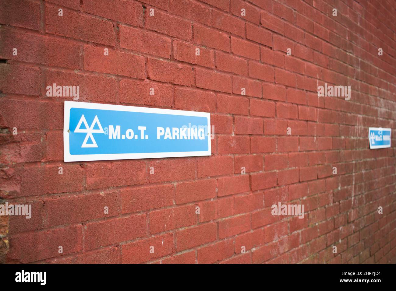Sign text of UK MOT testing sign on a brick red wall out doors Stock ...