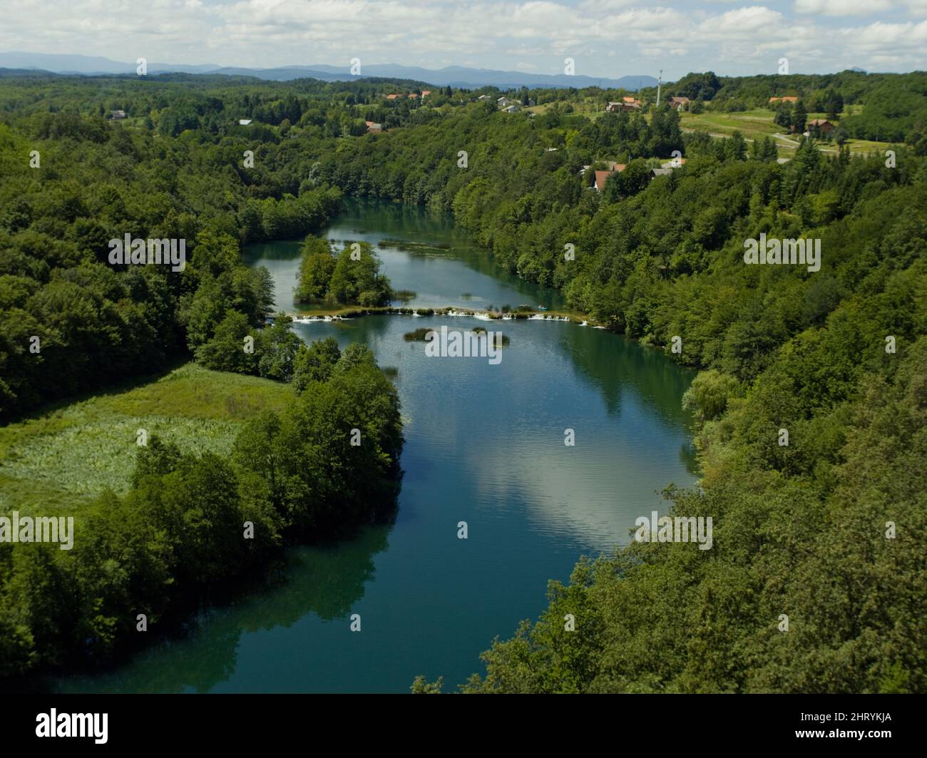 Landscape of The Mreznica surrounded by greenery on a sunny day in ...