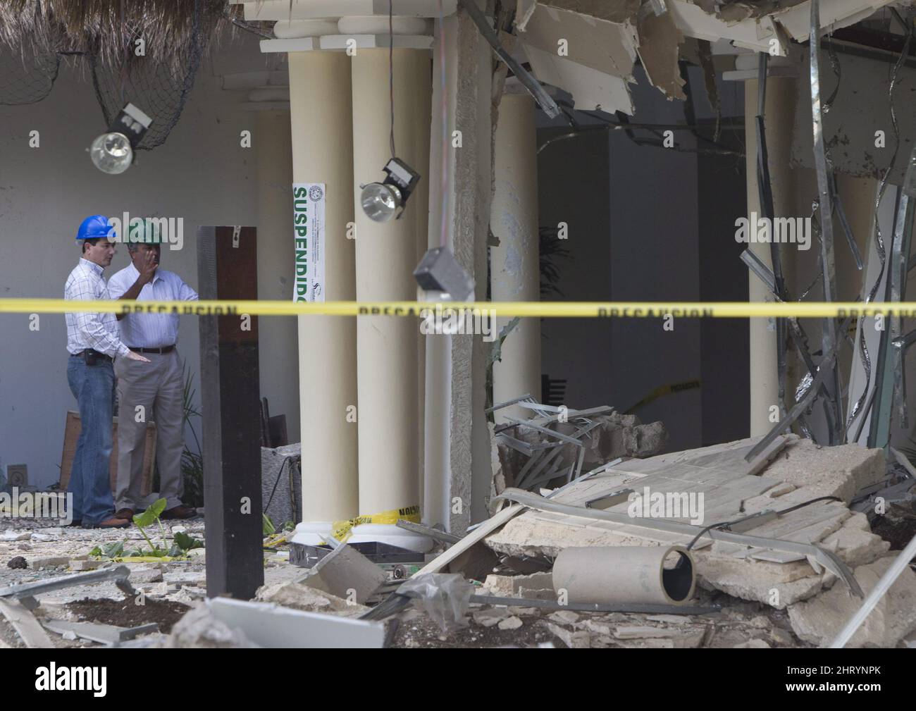 Workers survey the damage caused by an explosion at the Grand Princess ...